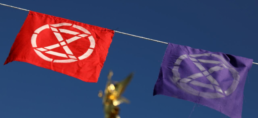 The Story Behind the Extinction Symbol Showing Up at Climate Change ...